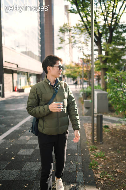 Solo asian men millennial gen Z travel alone in Osaka japan in November ...