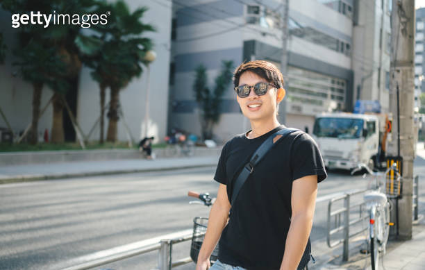 Solo asian men millennial gen Z travel alone in Osaka japan in November ...