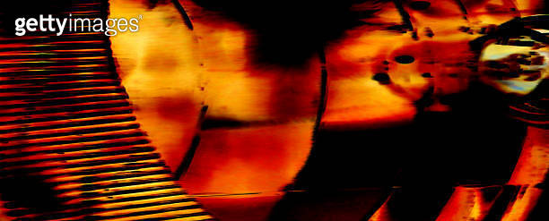 Afterburner flames shoot out from the nozzle of a jet engine, retouched ...