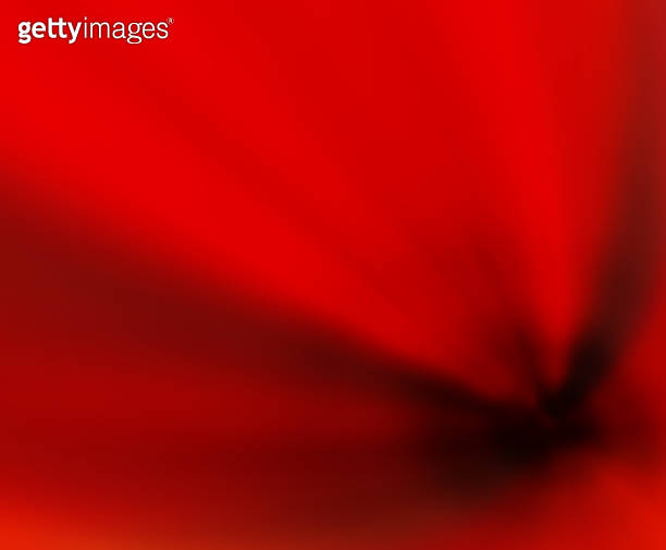 Red and black abstract texture with rays of light radiating from the ...