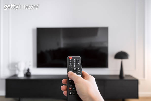 Woman hand hold remote control, press button and turn on television 이미지 ...