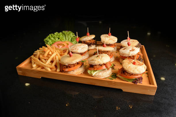 assorted mini burger canapés with meat and vegetable toast in party ...