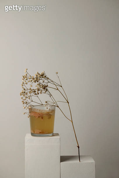 Dried flowers and dirty water glass. Creative minimalism concept. Still ...