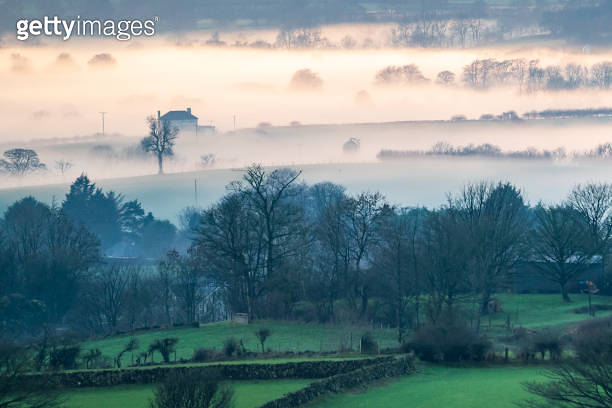 Mist forming over countryside in Northern Ireland on a winter evening ...