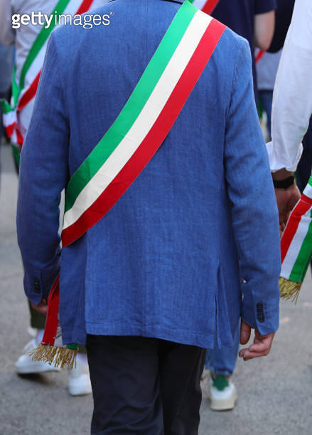 mayor walks through the streets with the Italian tricolor sash during ...