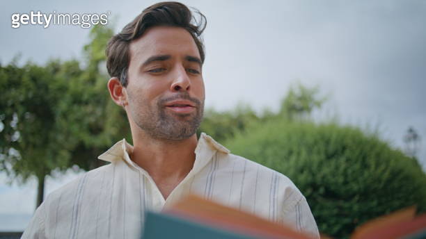 Groomed man reading novel aloud summer park closeup. Macho enjoying ...