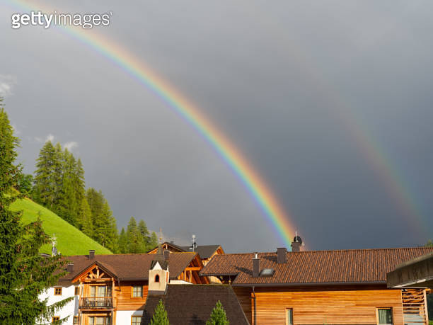Wonderful double rainbow at mountain. Contrast between the bright ...
