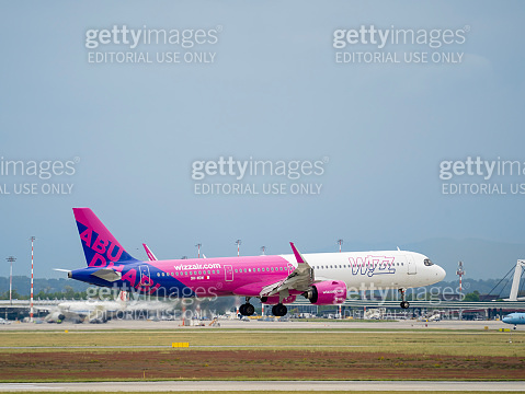 Wizzair Airbus A321 is landing at MXP Milano Malpensa international airport. Abu Dhabi livery ...