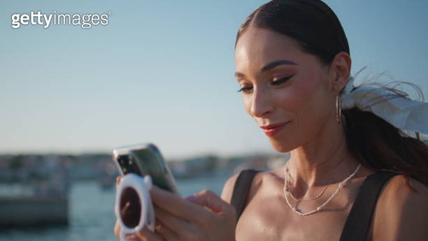 Relaxed girl typing message on summer waterfront close up. Woman ...