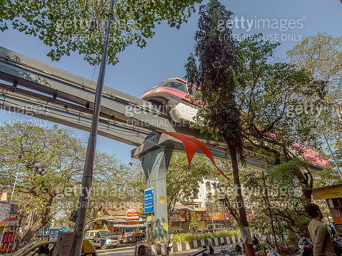 Tall multi-storied buildings behind the 30 feet high elevated mono-rail ...