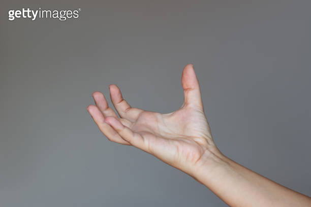 Female hand making a gesture like holding or grabbing something big ...