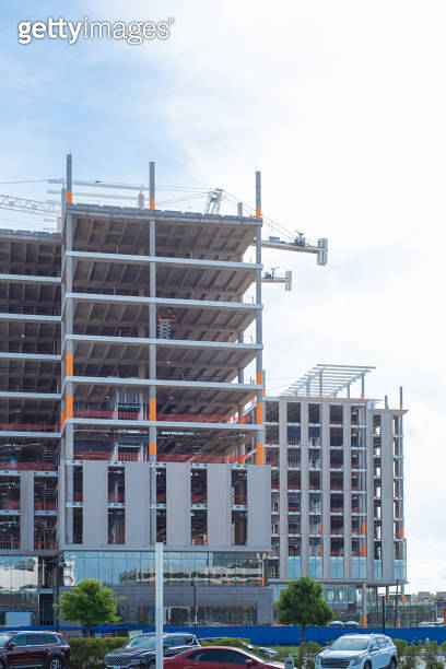 Busy downtown street with cars and construction site of concrete stud ...