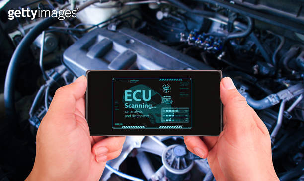 Auto mechanic checking ECU engine system with OBD2 wireless scanning ...