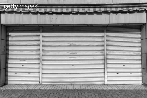 Closed steel shutter door of warehouse, storage or storefront for metal ...