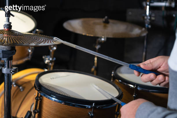 Close-up of drumsticks on drums in the hands of a drummer, selective ...