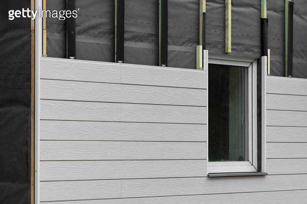 wood texture composite cladding installation on house facade. WPC ...