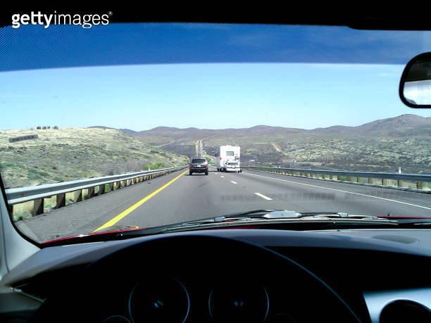 The view out the front window of a car travelling down an American ...