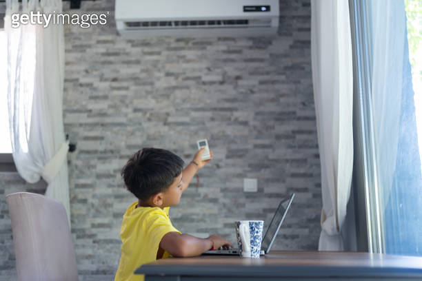 Overheated Child Turning On Air Conditioner While Studying At Home ...