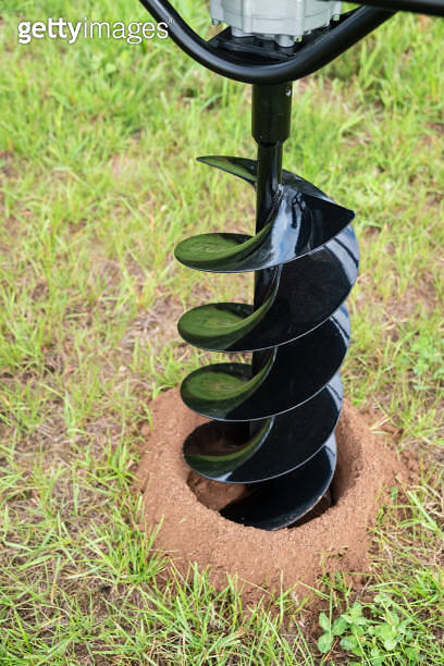 The drilled ground. The land hole. Borer for the fence installation ...