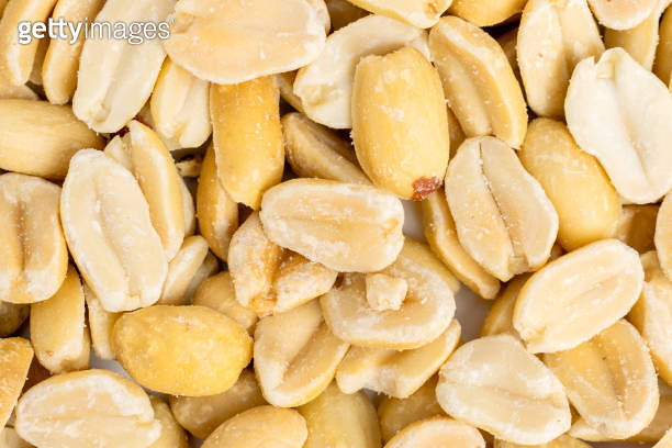 Top view of a pile of roasted peeled peanut grains, delicious groundnut ...