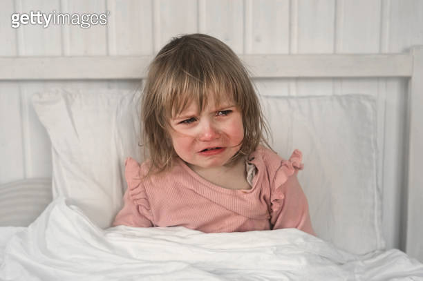 Crying 3 years old girl, tears streaming down her cheeks, expressing ...