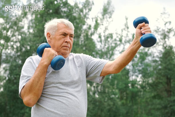 Old man exercising with dumbbells outside. Physical therapy. Elderly ...