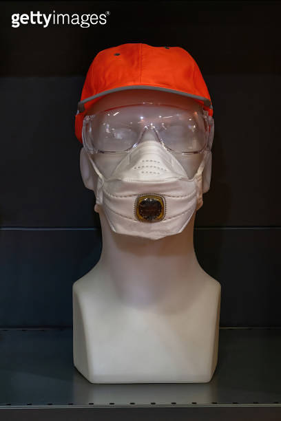 A mannequin equipped with essential safety gear, including a hard hat ...