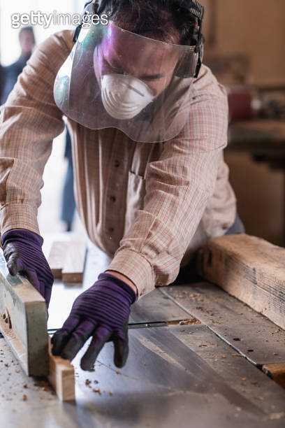 Carpenter woodworking, using thickness planer machine in carpentry ...