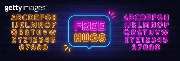 Free Hugs neon sign in the speech bubble on brick wall background ...