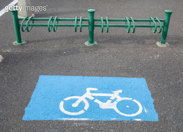 Blue sign painted into the pavement to indicate a bike rack. 이미지 ...