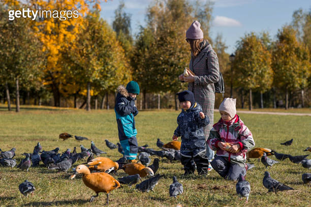 A family with three children. A mother with many children and kids in ...