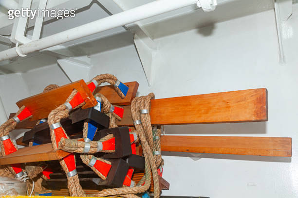 Nautical rope ladder twisted into a roll, close-up. Pilot storm ladder ...