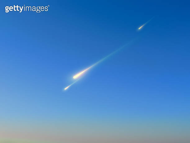 Meteorites in a clear blue sky. Meteor trails, beautiful shooting stars ...