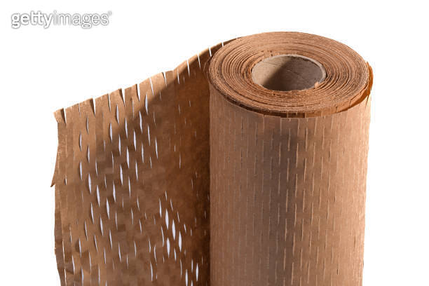 Pre-cut brown paper parcel filler roll on a white background, isolated ...