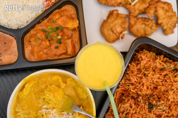 Top view of a table full of takeaway food from an Indian restaurant ...