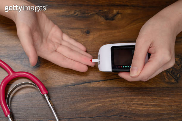 Check your blood glucose level with a glucometer, test your blood with ...