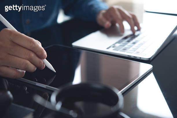 Close up of business man hand using stylus pen on digital tablet and ...