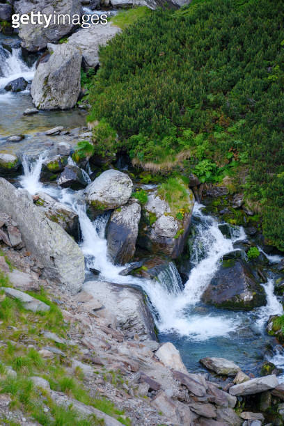 mountain water stream among the rocks on the hillside. view from above ...
