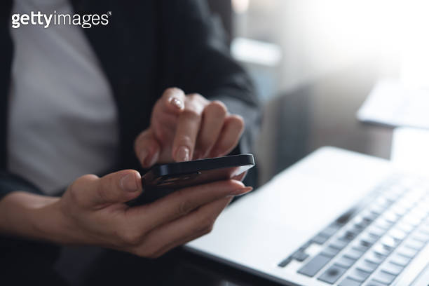 Close up of business woman hand using mobile phone during working on ...