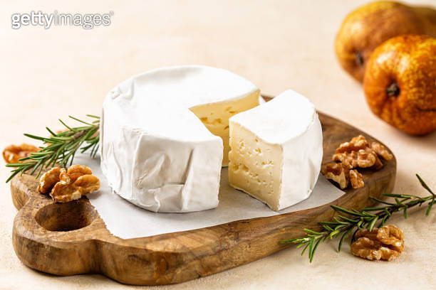Caciotta, creamy, soft italian cheese. A beginner cheese on a wooden ...