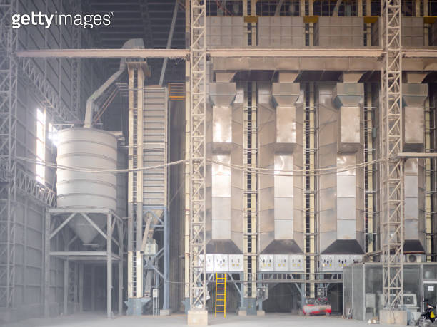 Rice milling factory interior, front view of paddy drying machine. Post ...
