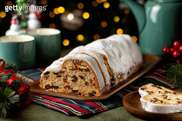 Served table with Stollen cake, tea cups and pot. German Christmas ...