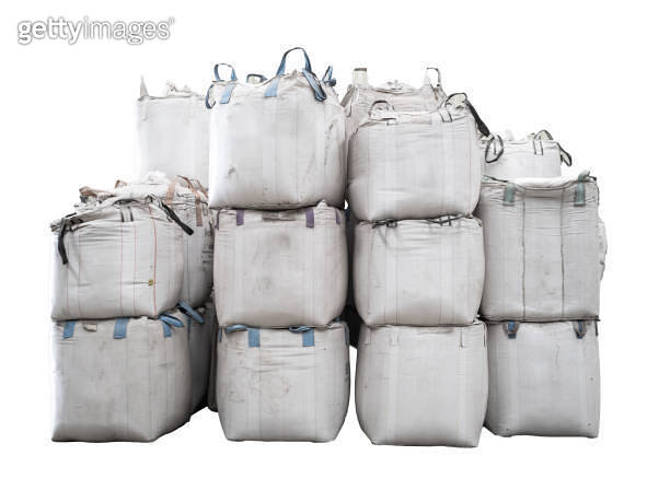 Stack of jumbo bags of raw material in warehouse, isolated on a ...