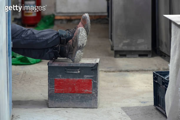 worker rests in the workshop with his feet on a box 이미지 (2154736670 ...
