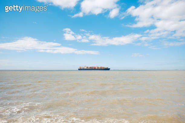 A container ship at sea. Sea cargo transportation. Sea and sky ...