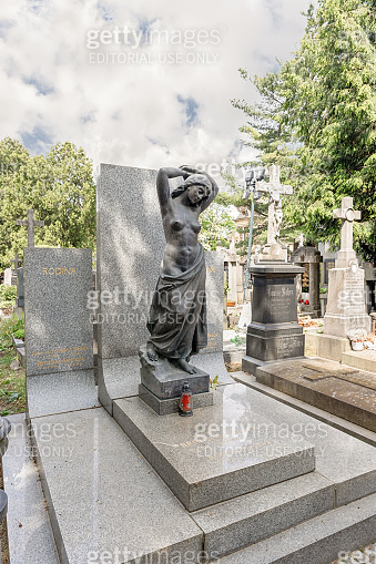 Statue of a half naked dancer as tombstone on grave in cemetery of ...