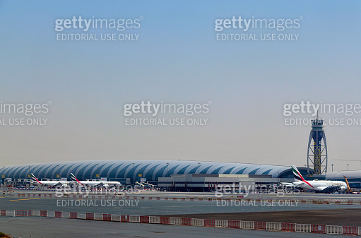 Emirates aircraft and control tower at Dubai International Airport DXB ...