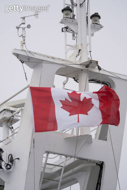 The Canadian national flag waving on top of a BC Ferries vessel in ...