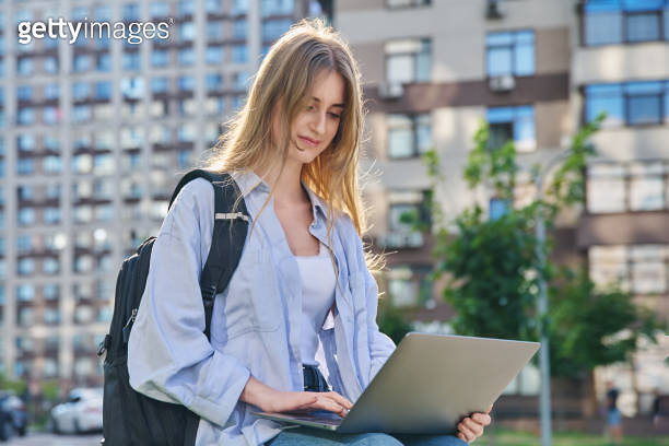 Young female college student using laptop computer outdoor 이미지 ...