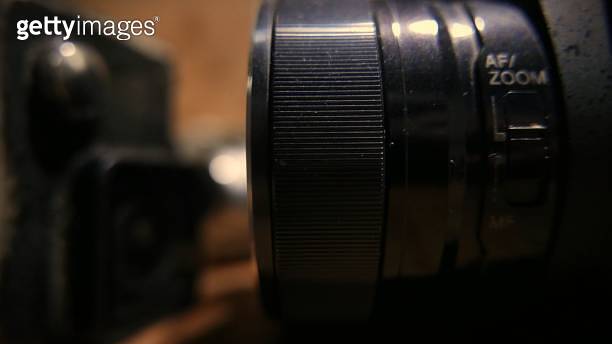 Close-up shot of three digital cameras on a table: a professional ...